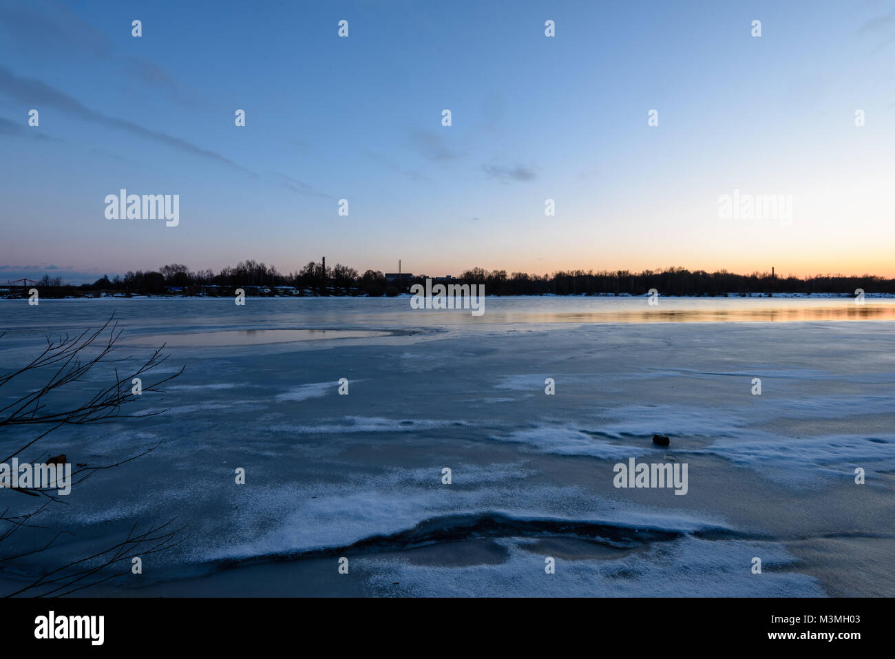 colorful winter sunset on frozen river ice with dramatic clouds Stock ...