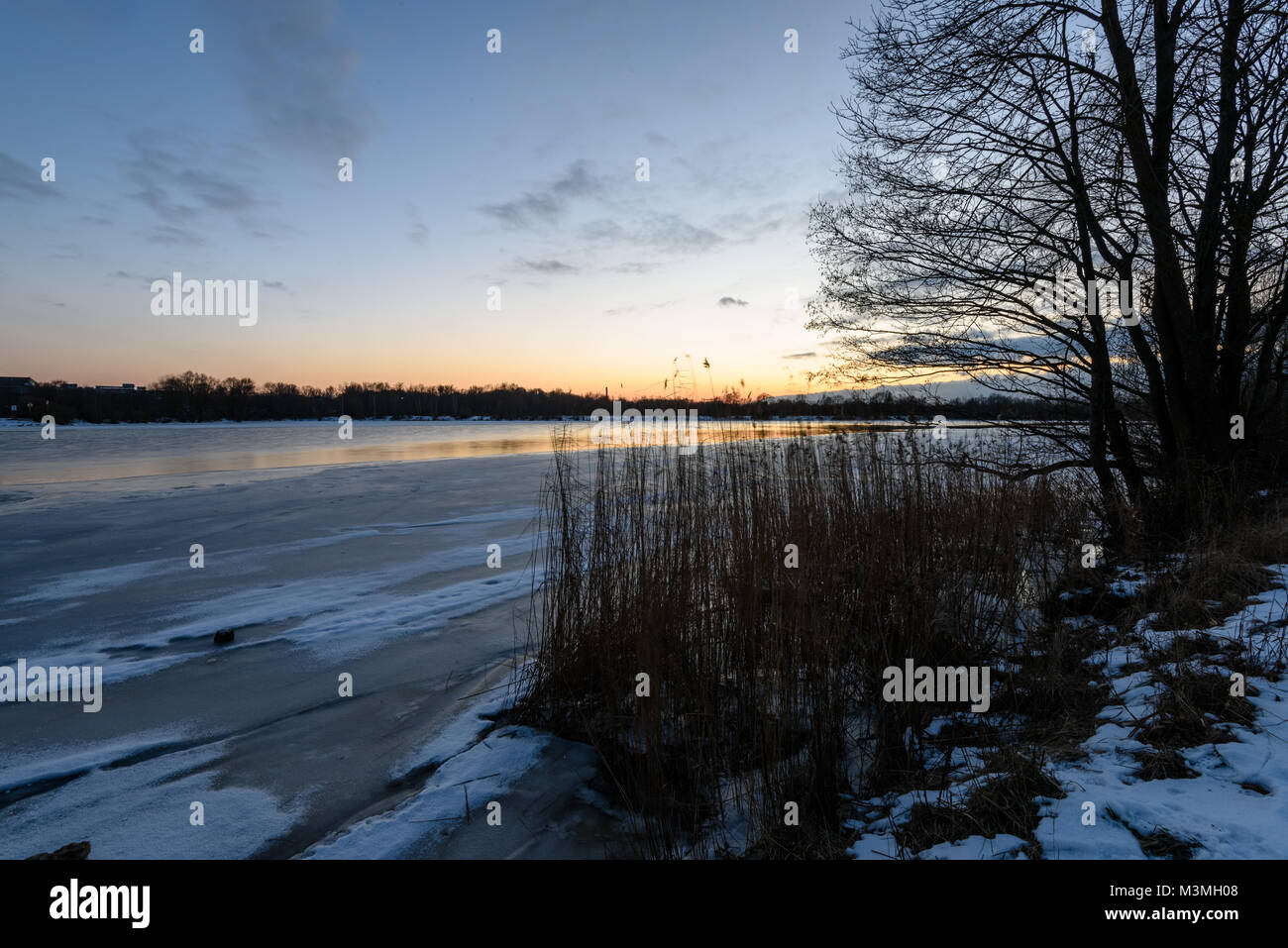 colorful winter sunset on frozen river ice with dramatic clouds Stock ...