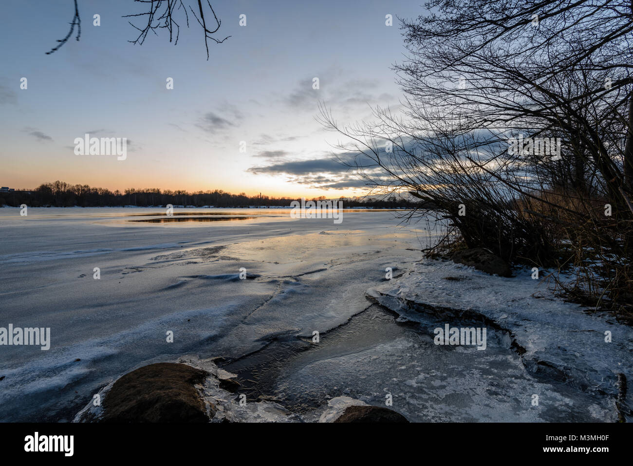 colorful winter sunset on frozen river ice with dramatic clouds Stock ...