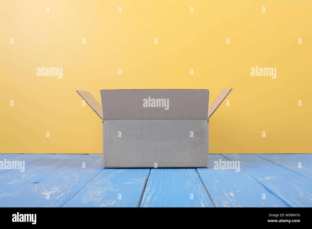 Postage and packing service - Open Package front view on a blue wood ...