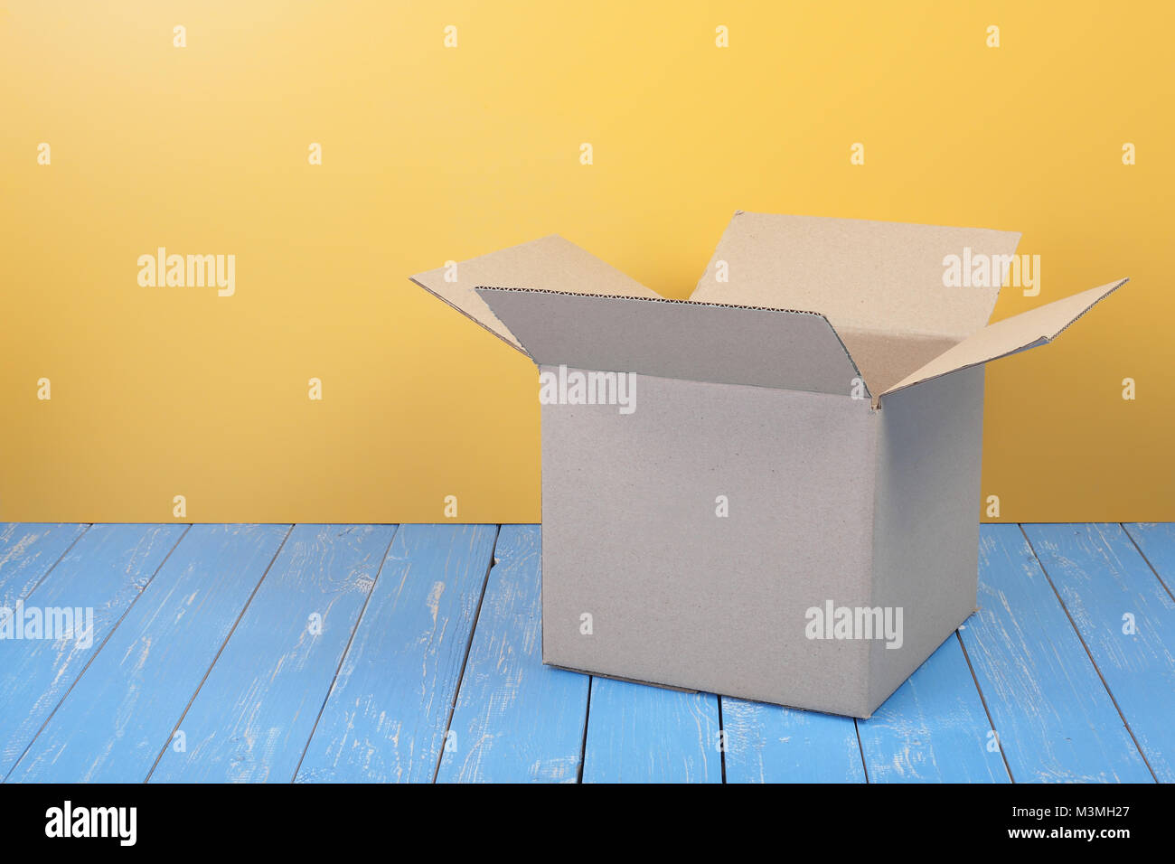 Postage and packing service - Open Package on a blue wood and yellow ...