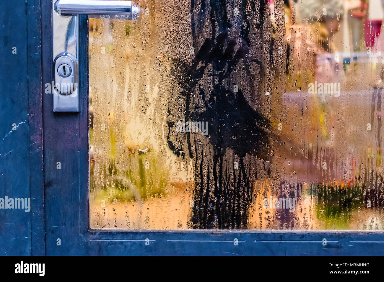 Blue Iron Door. Fogged glass with drops of water from the rain ...