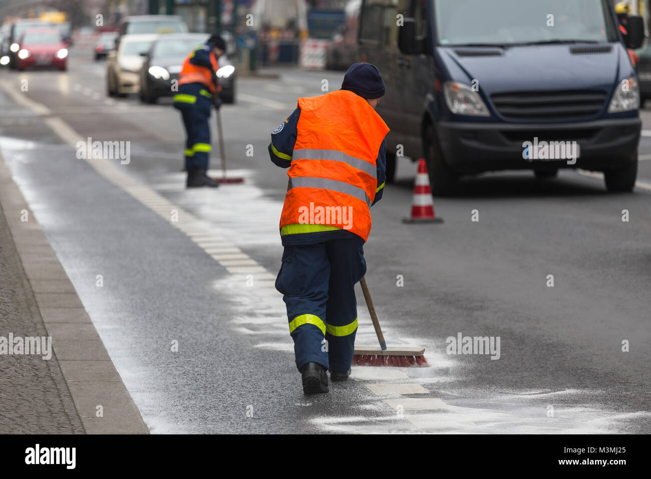 german thw eliminating oil traces on a street Stock Photo - Alamy