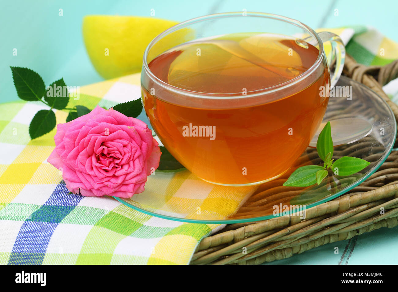 Lemon tea in transparent cup and pink rose Stock Photo - Alamy