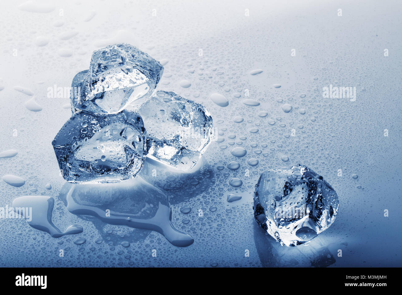 Ice cubes on wet table with drops of water Stock Photo - Alamy