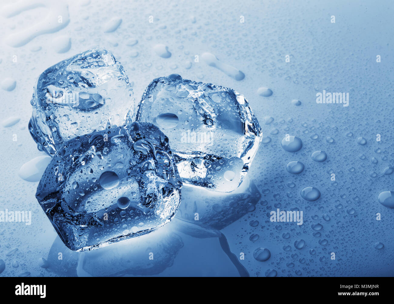 Three ice cubes on wet background Stock Photo - Alamy