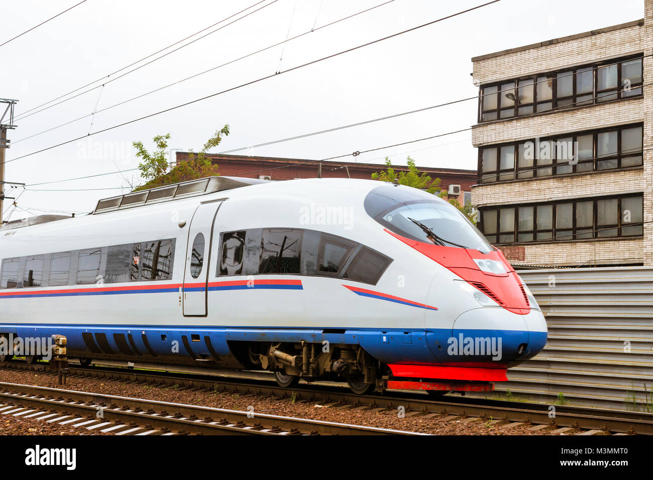 Modern hybrid electric locomotive Sapsan pulling a high-speed train on ...