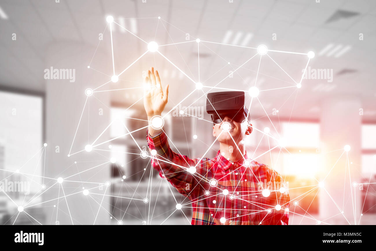 Guy wearing checked shirt and virtual mask reaching hand to touch ...