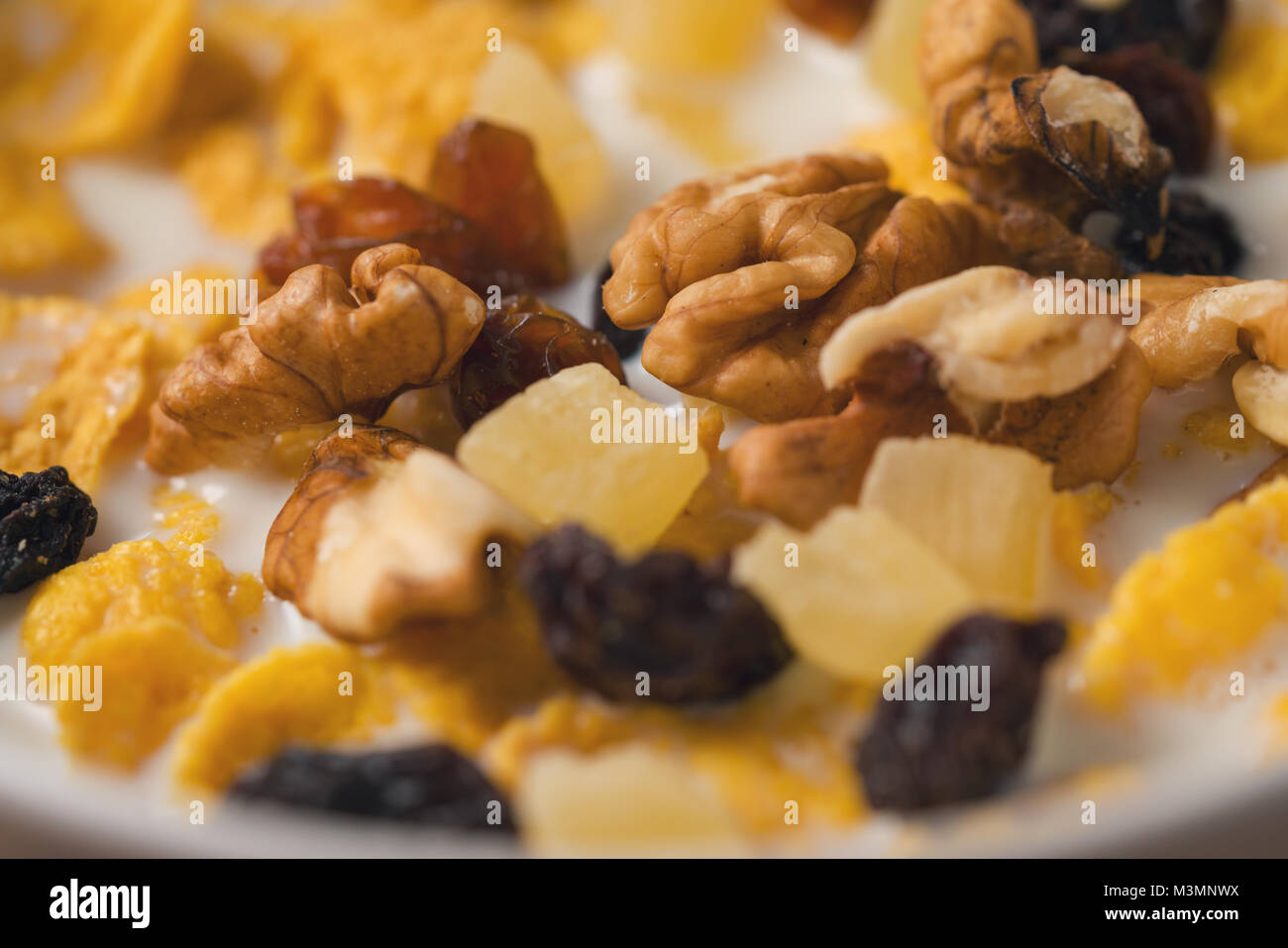 corn flakes with nuts and fruits in white bowl Stock Photo - Alamy