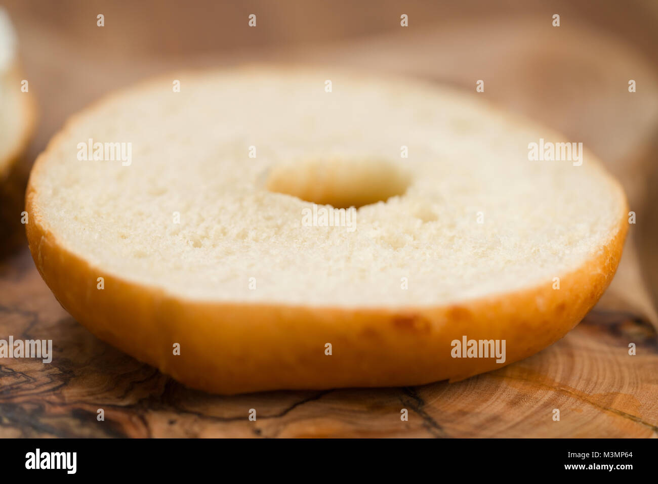 sliced bagel on wood board Stock Photo - Alamy