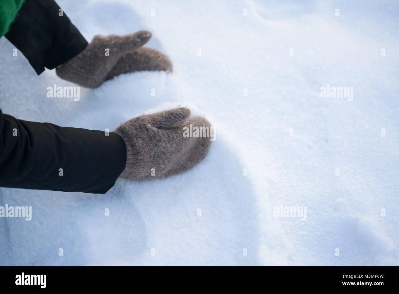 female teen hands in mittens grabbing fresh snow Stock Photo - Alamy