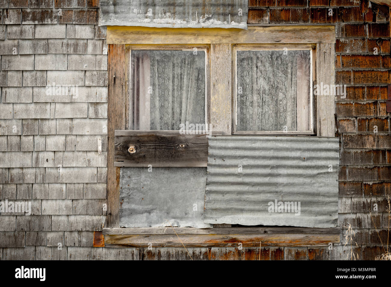 Patched and mended window in an abandon homestead in Idaho Stock Photo ...