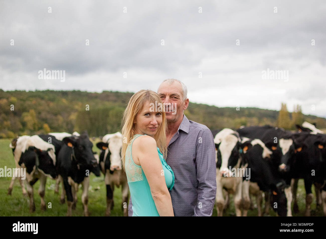 Outdoors Portrait of the Farmer and His Wife Hugging in Front of Their ...