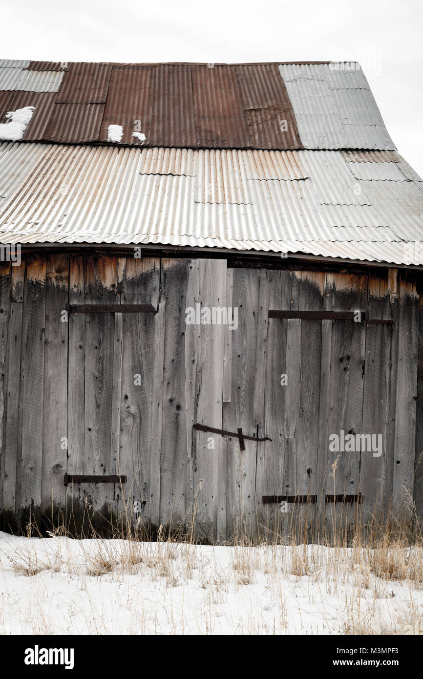 Side of an old Idaho barn in winter with snow on the ground Stock Photo ...