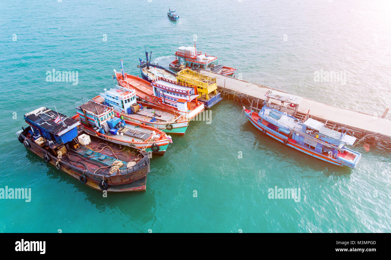 Wooden fishing boats floating at the harbor photo in outdoor sunlight ...