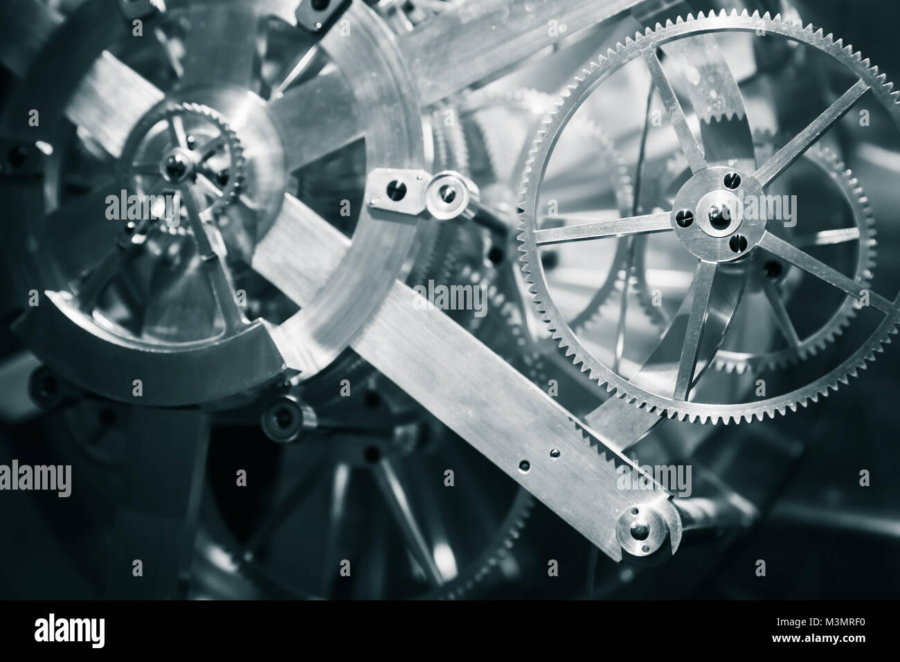 Mechanical clock mechanism, close-up fragment with shiny gears, blue ...