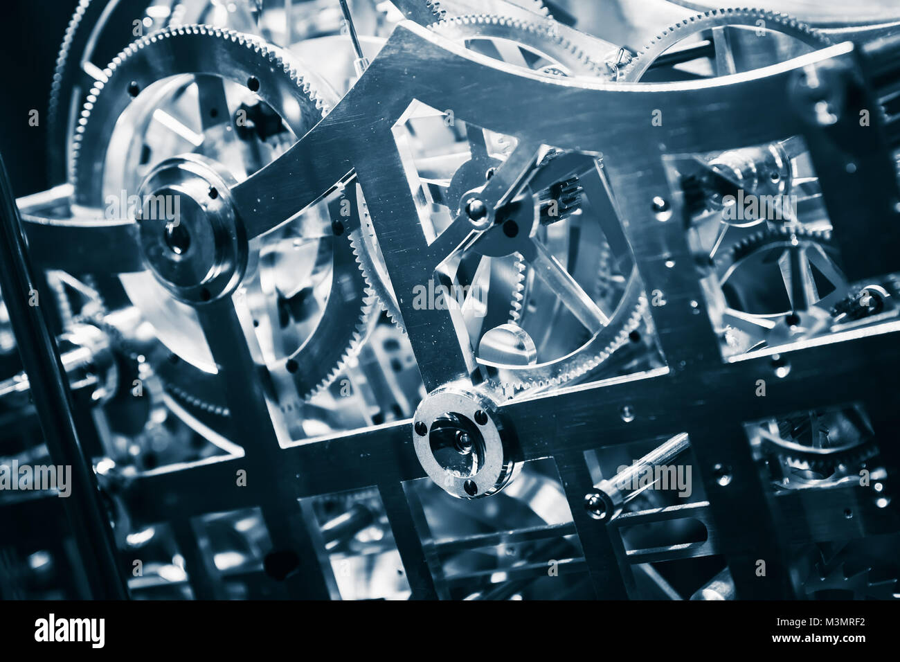 Mechanical clock close-up fragment with shiny gears, blue toned photo ...