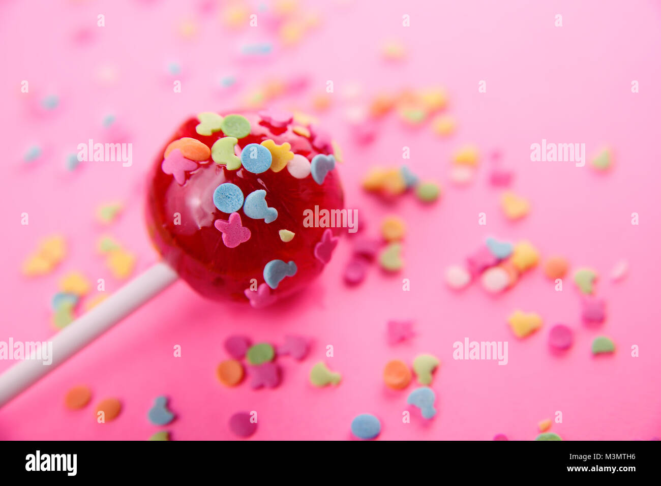 pink round lollipop close-up on pink background Stock Photo - Alamy