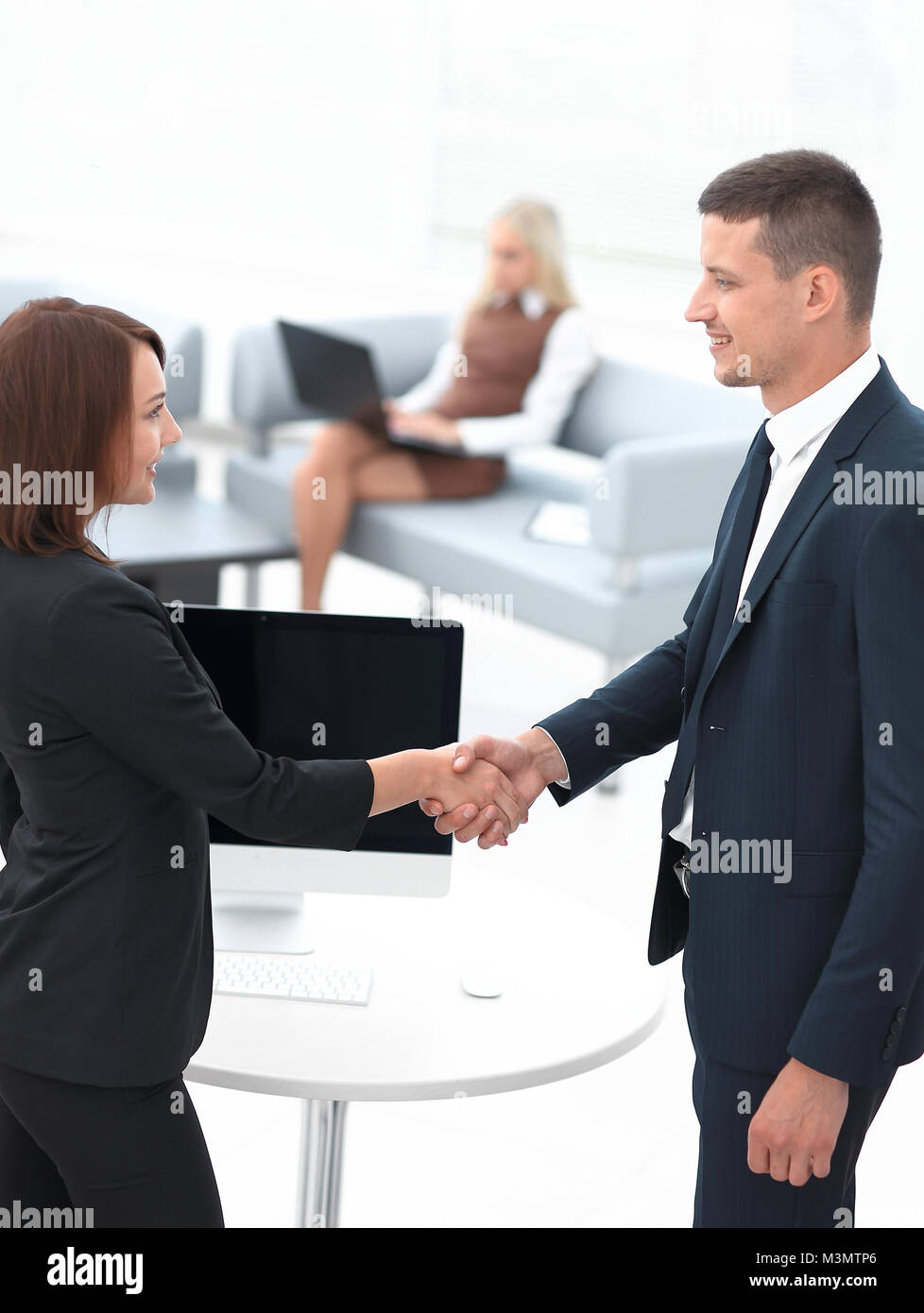 handshake business partners at the negotiating table Stock Photo - Alamy