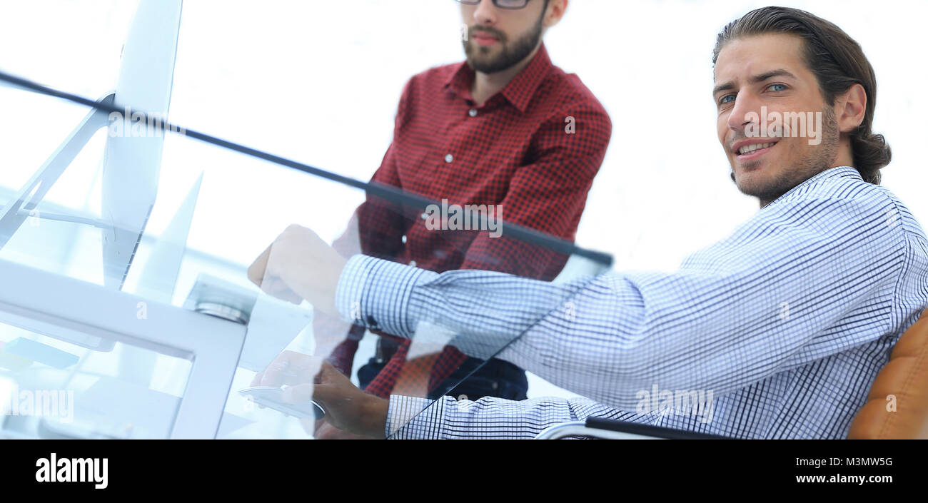 bottom view.businessman sitting behind a Desk Stock Photo - Alamy