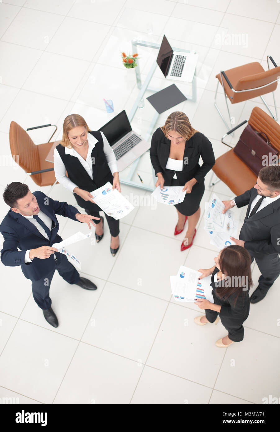 view from the top.business team working with documents standing in the ...