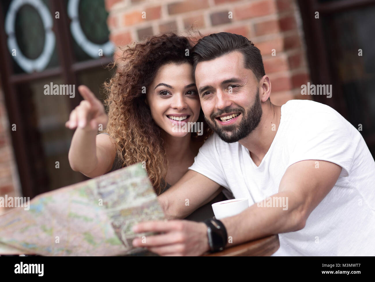A picture of tourists looking at map in a cafe Stock Photo - Alamy