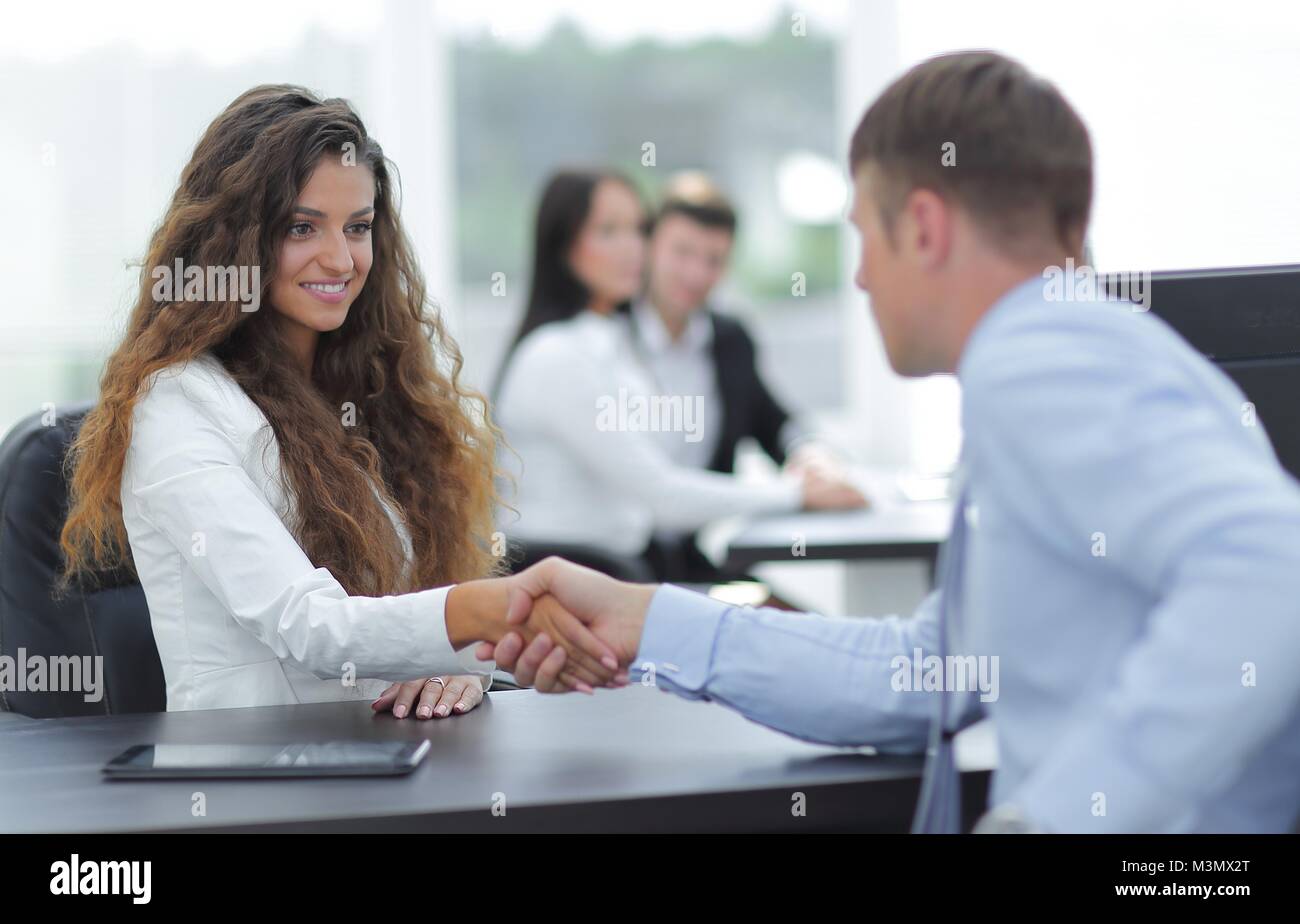 handshake Manager and the client in the office Stock Photo - Alamy
