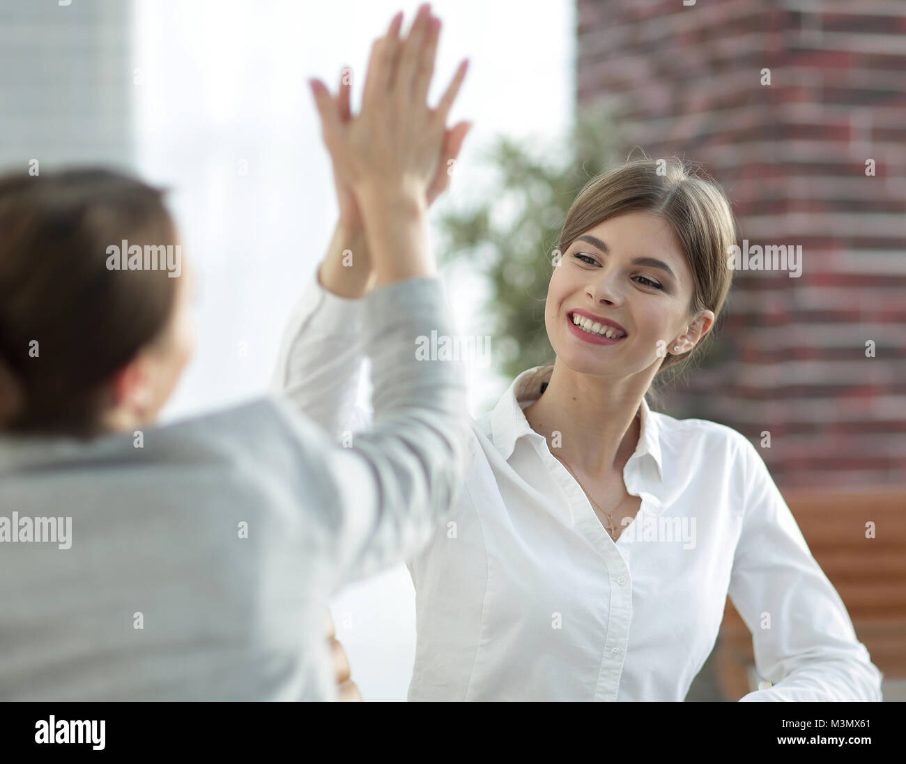 members of the business team giving each other a high five Stock Photo ...
