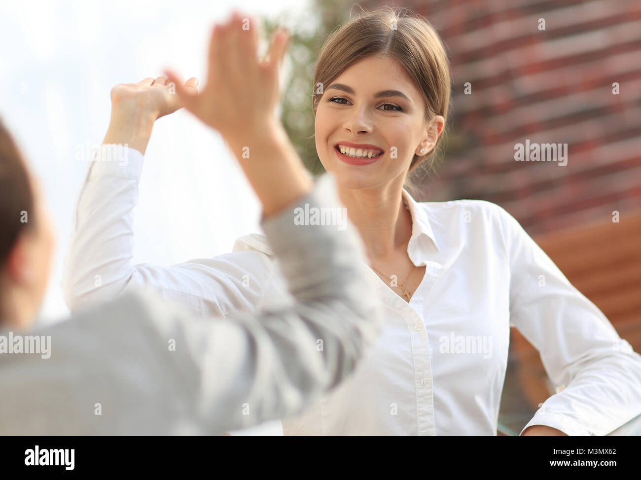 members of the business team giving each other a high five Stock Photo ...