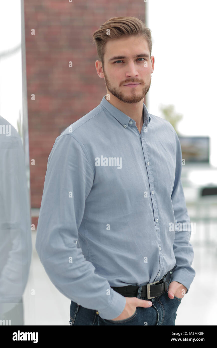 Confident young businessman posing in an office Stock Photo - Alamy