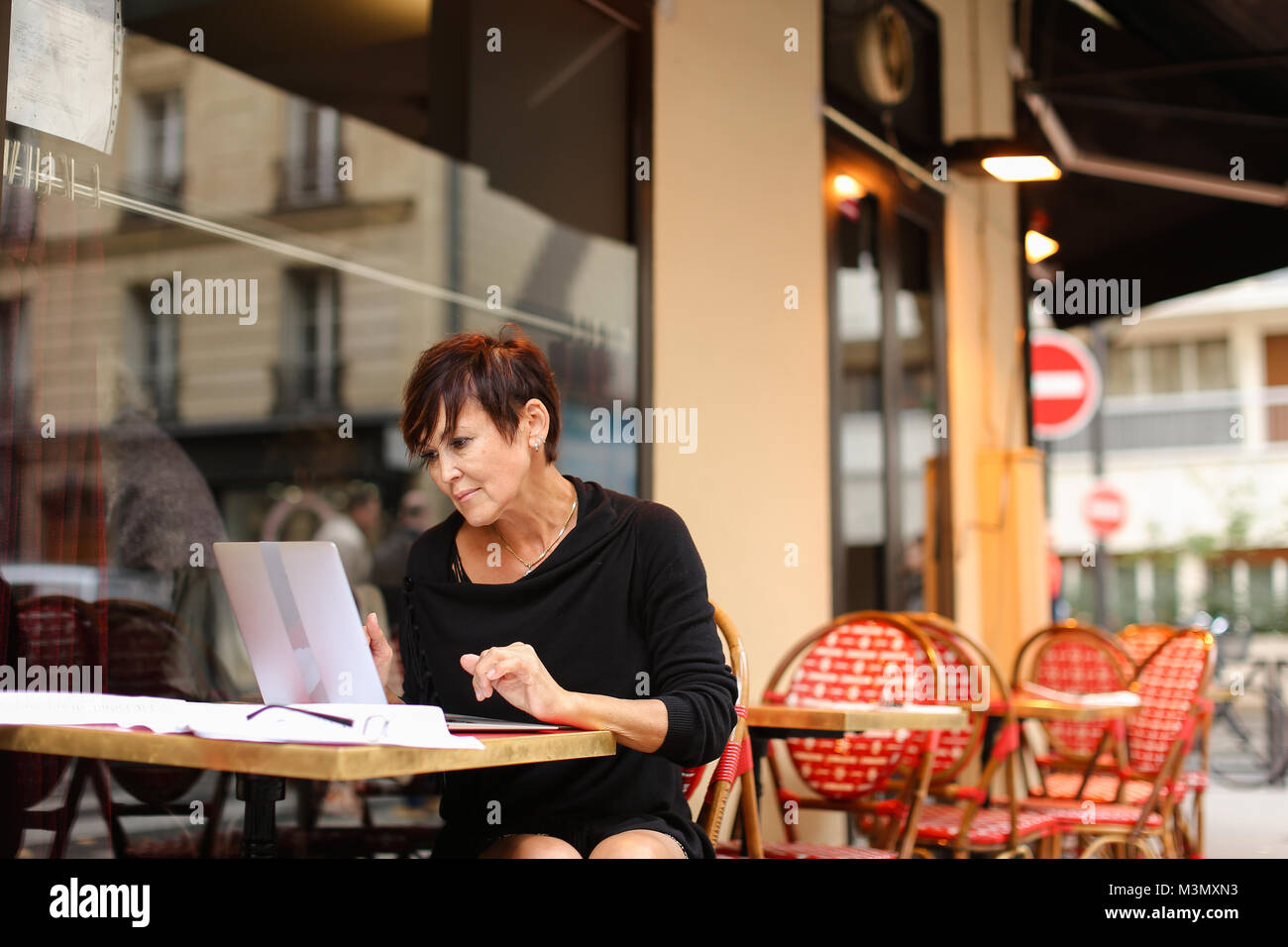 aged female screenwriter working with scenario in laptop Stock Photo ...
