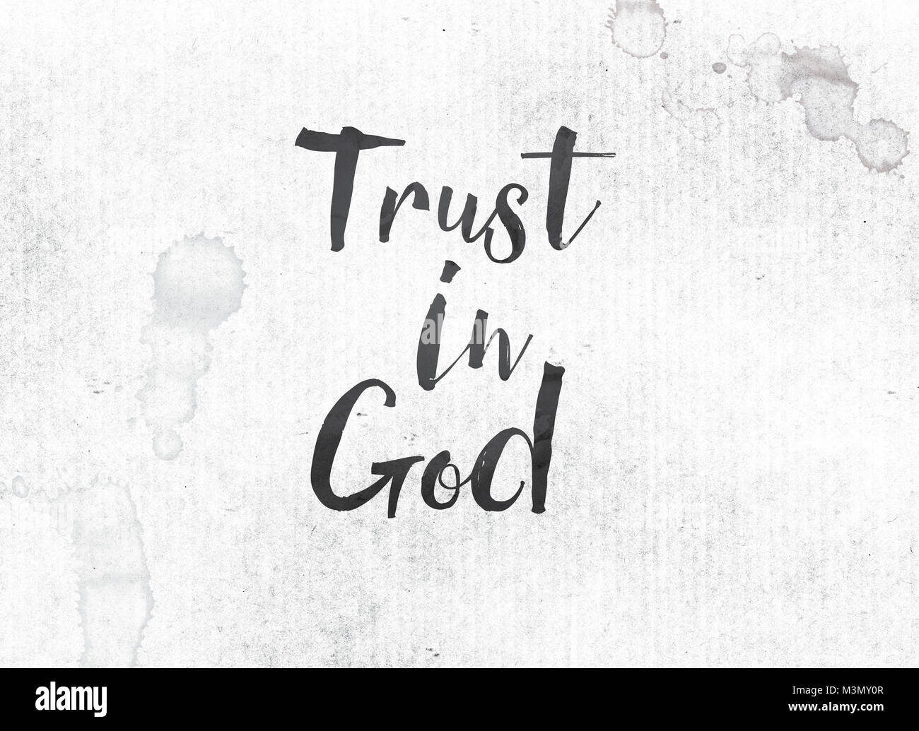 The words Trust in God concept and theme painted in black ink on a ...