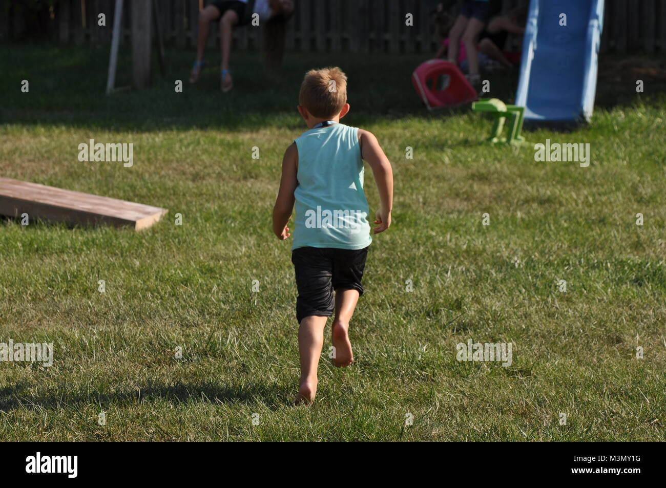 Young Boy Running Away Stock Photo - Alamy