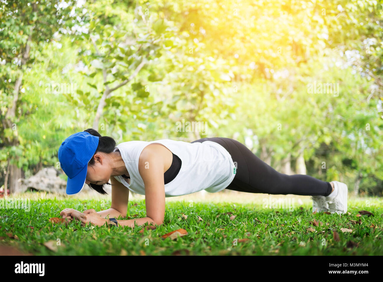 hand push-up. Confident muscled young women wearing sport wear and ...