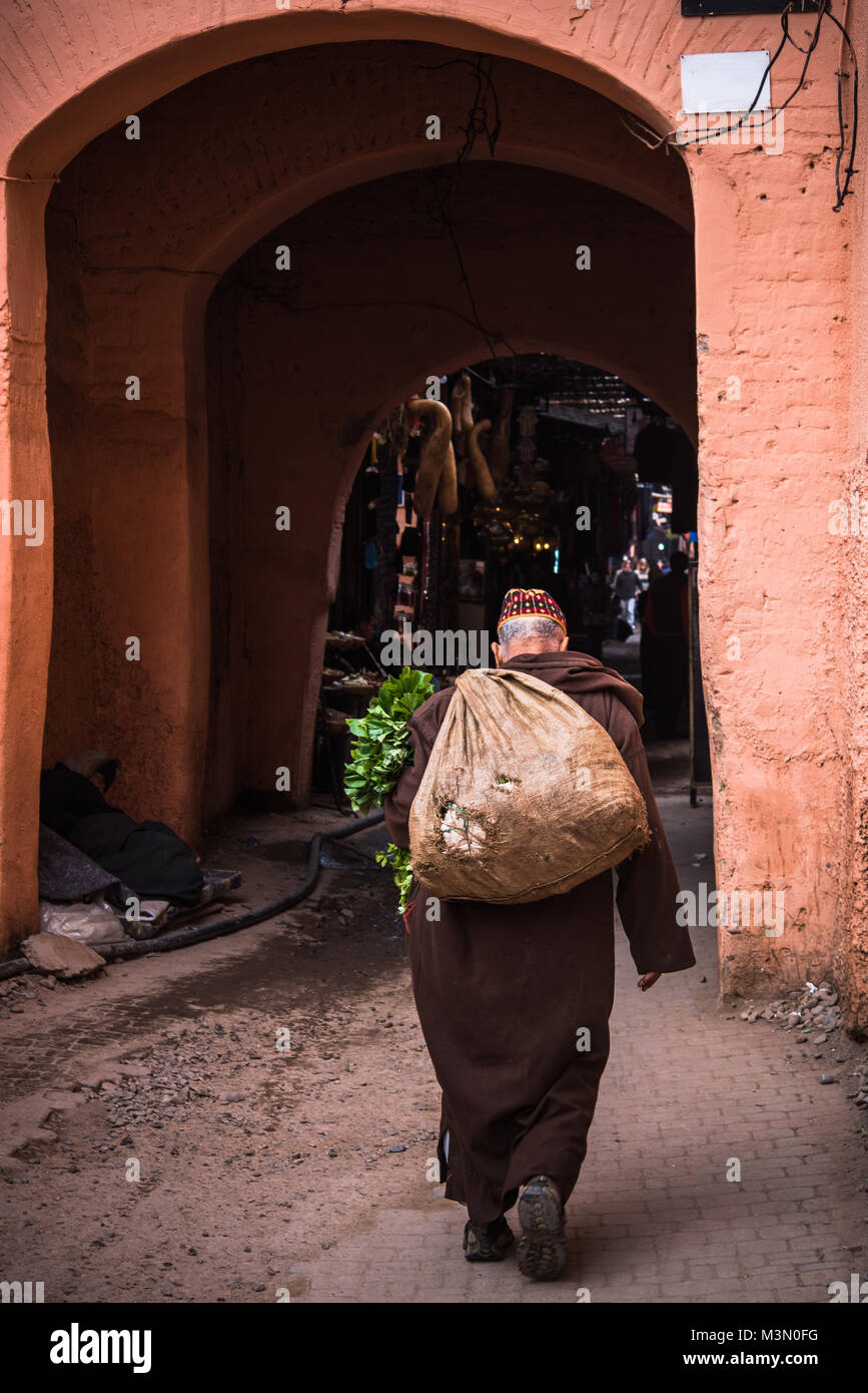 Old man walking in traditional clothing in Morocco Stock Photo - Alamy