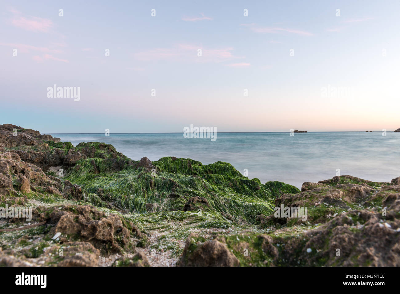 Long exposure photograph of the shore of the coast of Cala Moll in the ...