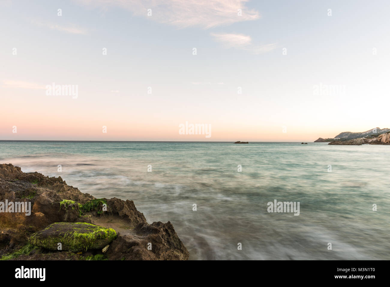 Long exposure photograph of the shore of the coast of Cala Moll in the ...