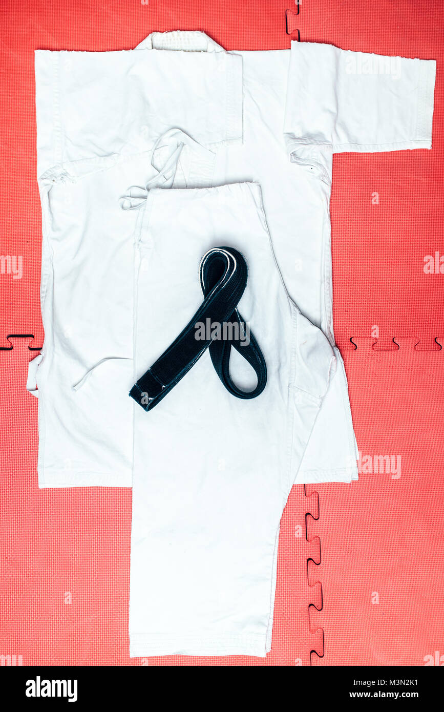 Martial arts, white kimono and black belt closeup, nobody. Fighters ...