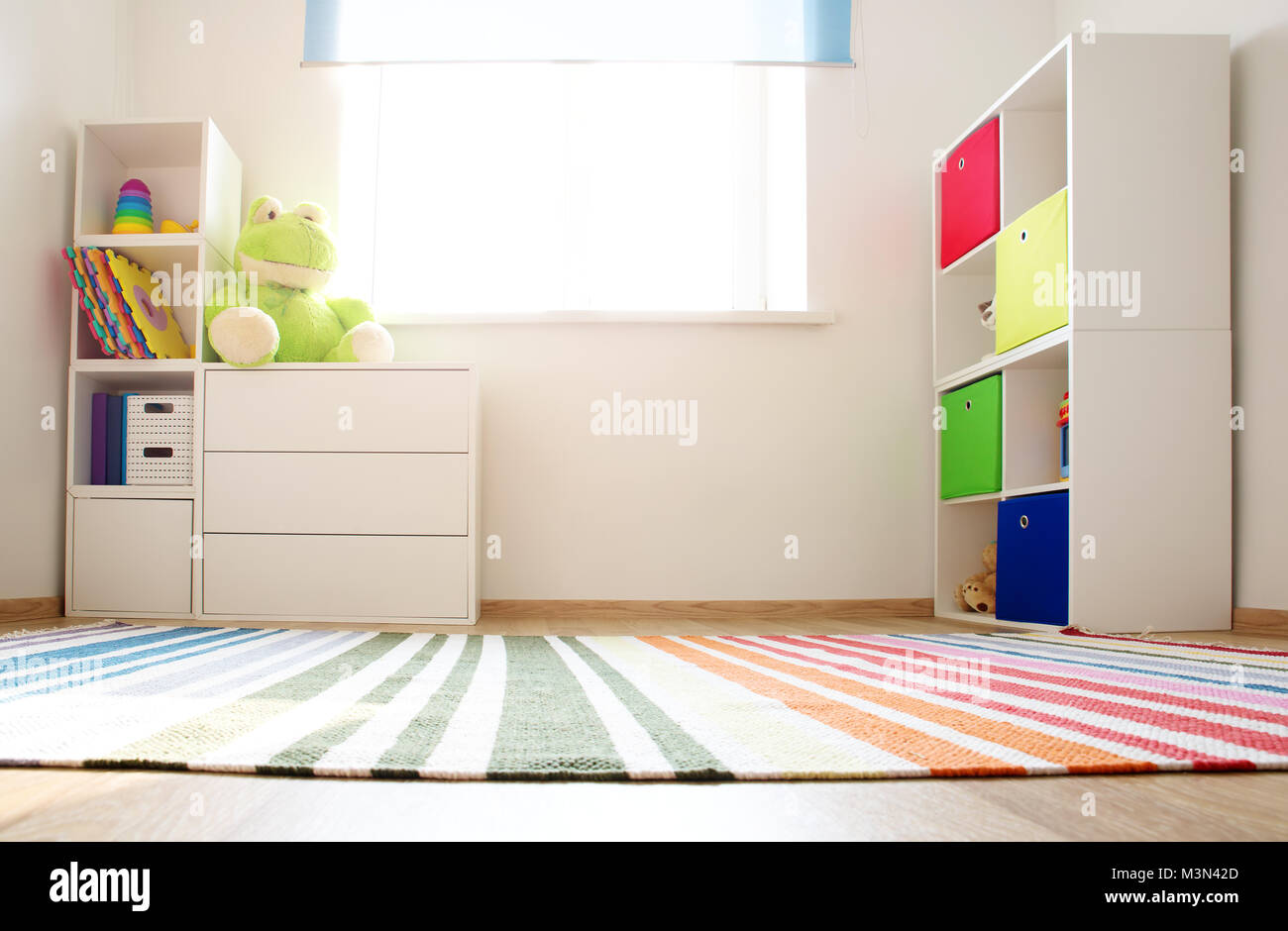 Colourful children rooom with white walls and furniture Stock Photo - Alamy