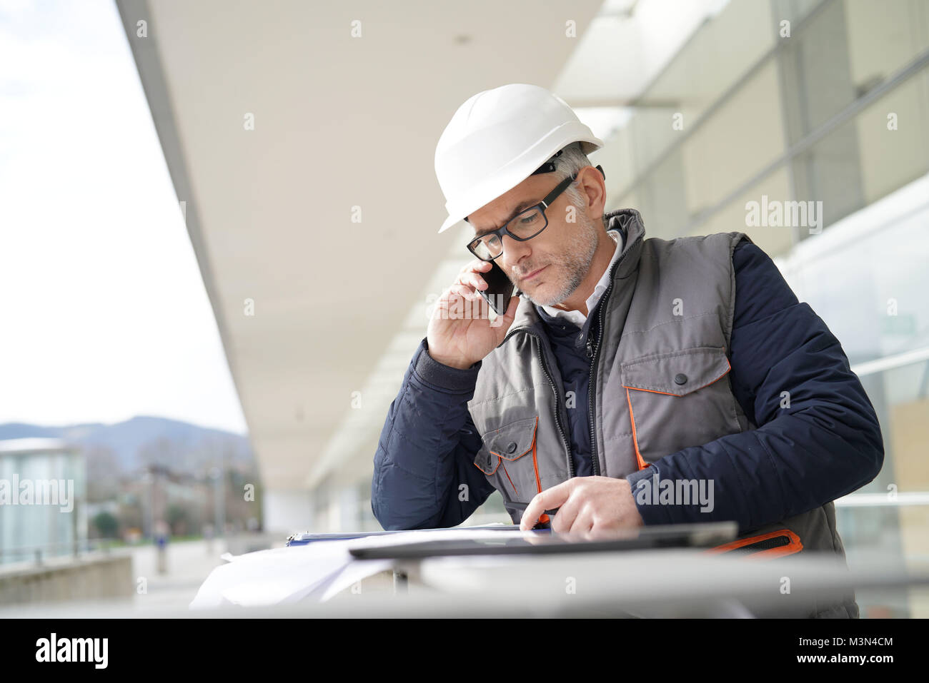 Engineer working on outdoor project and talking on phone Stock Photo ...