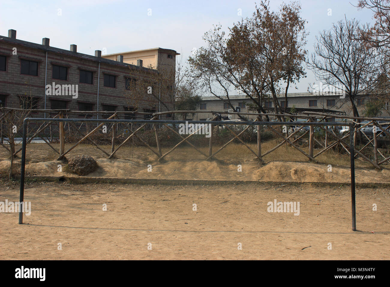 Football goal post without net in a dry football field, at a school in ...