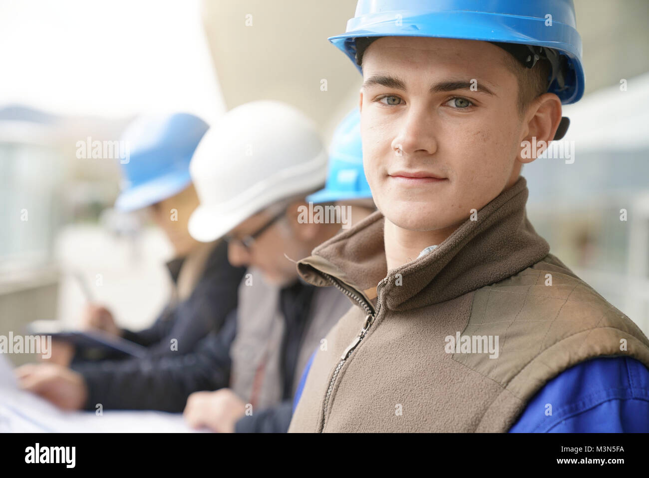 Portrait of young man in construction industry training Stock Photo - Alamy