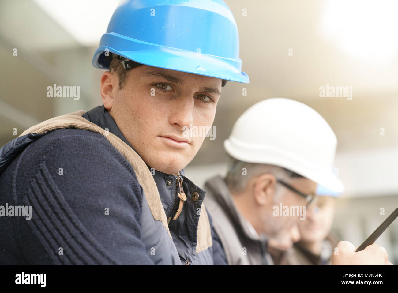 Portrait of young man in construction industry training Stock Photo - Alamy