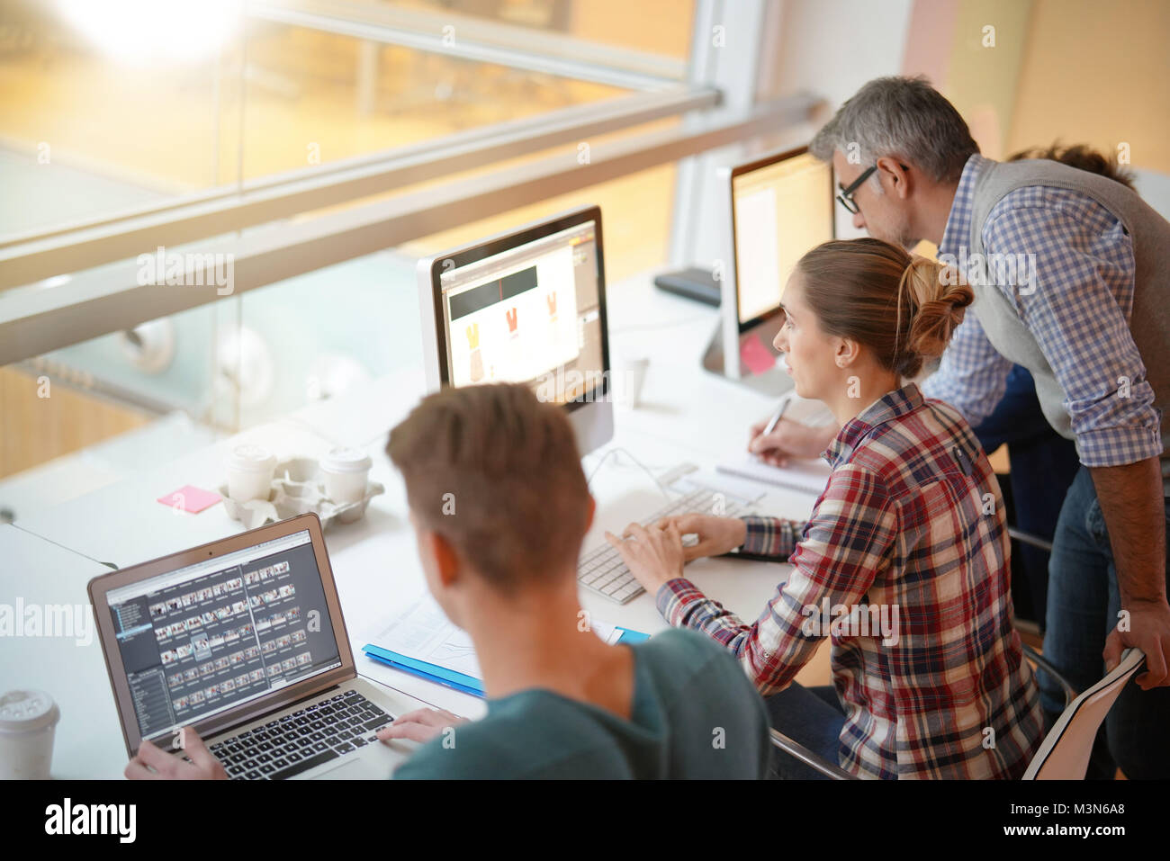 Teacher with students in computing class Stock Photo - Alamy