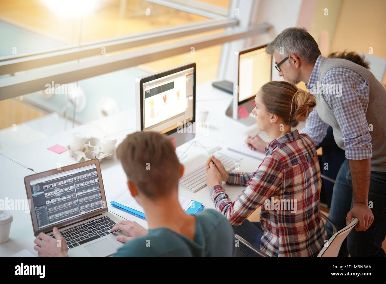 Teacher with students in computing class Stock Photo - Alamy