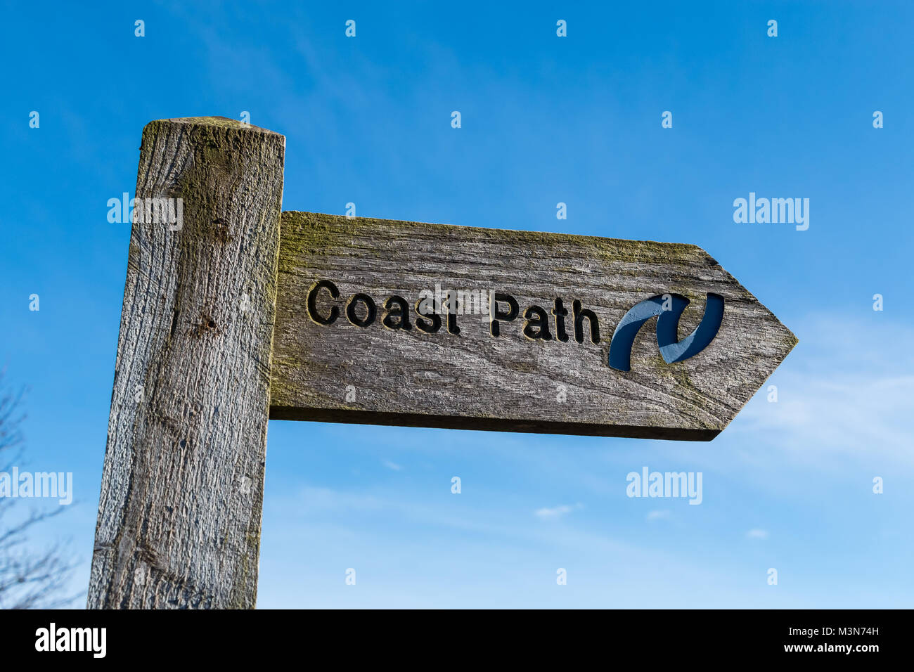 Coast path signpost with emblem of the Northumberland Coast long ...
