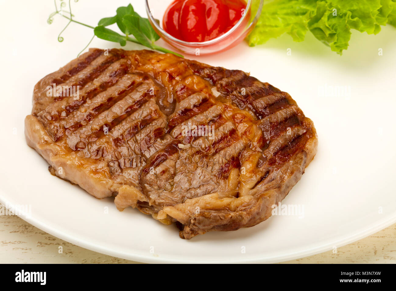 Grilled Rib eye steak with sauce Stock Photo - Alamy