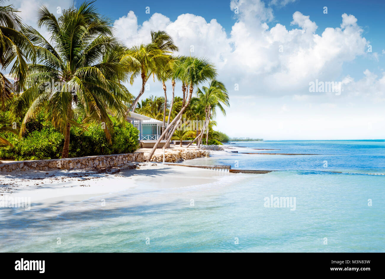 Beachfront bungalow on a tropical island Stock Photo - Alamy