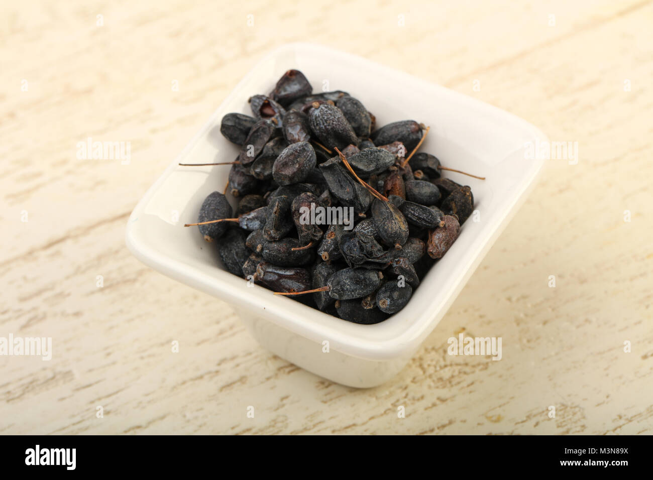 Dry barberry in the bowl over wooden background Stock Photo - Alamy
