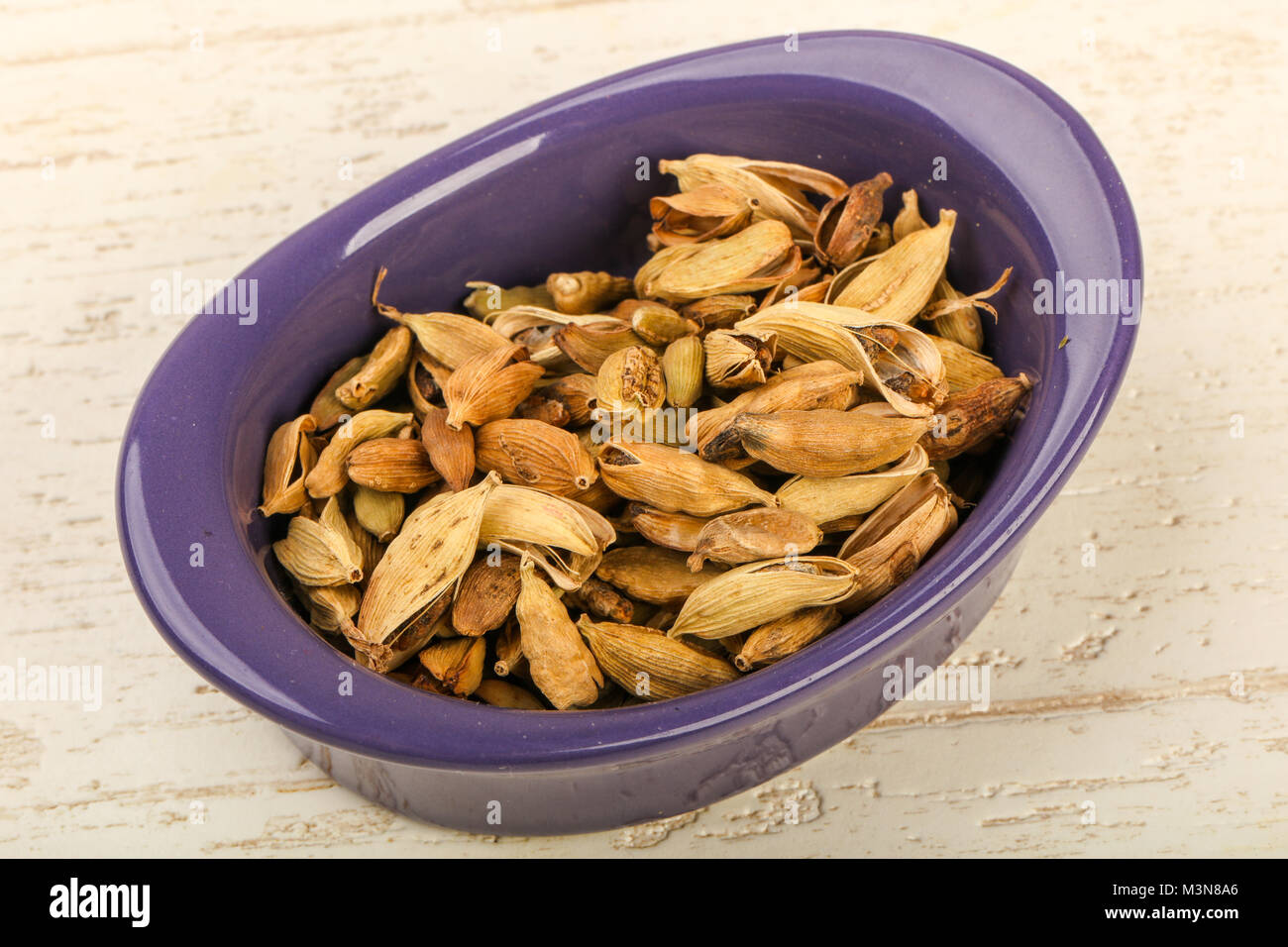 Dry cardamom seeds heap in the bowl Stock Photo - Alamy